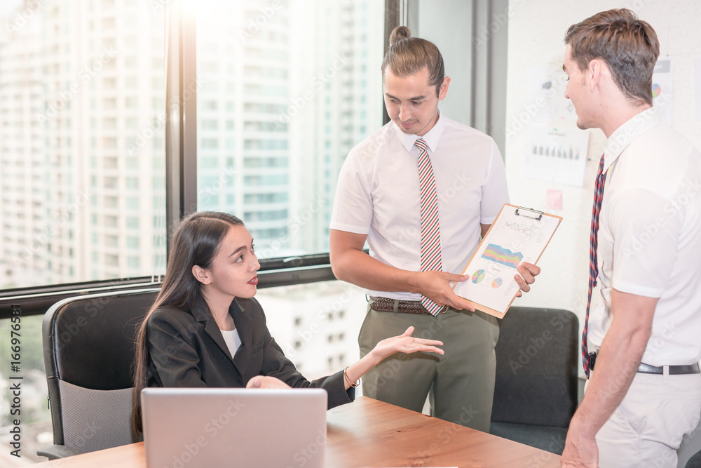 Young manager presenting whiteboard to his colleagues about financial ...