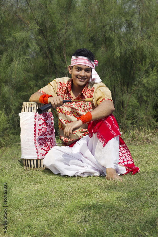 Portrait of a Bihu dancer sitting with a dhol Stock Photo | Adobe Stock