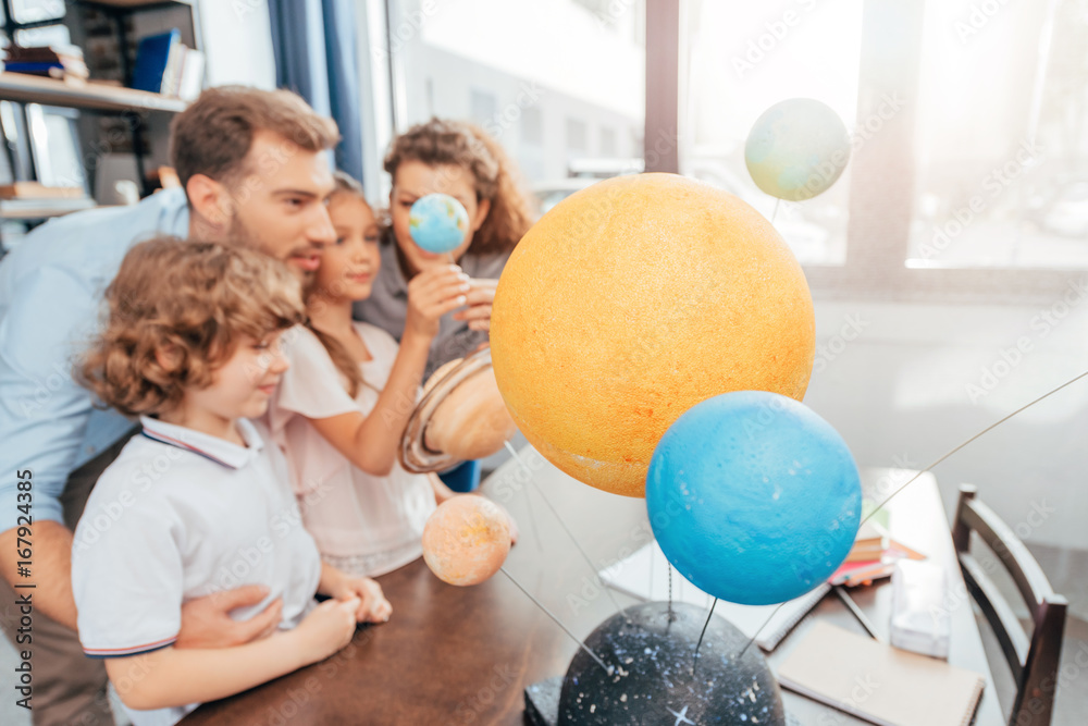 young happy family making solar system model for school project Stock ...