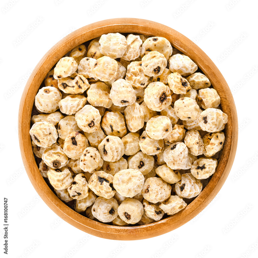 Tiger nuts in wooden bowl. Blanched and dried tubers of Cyperus ...