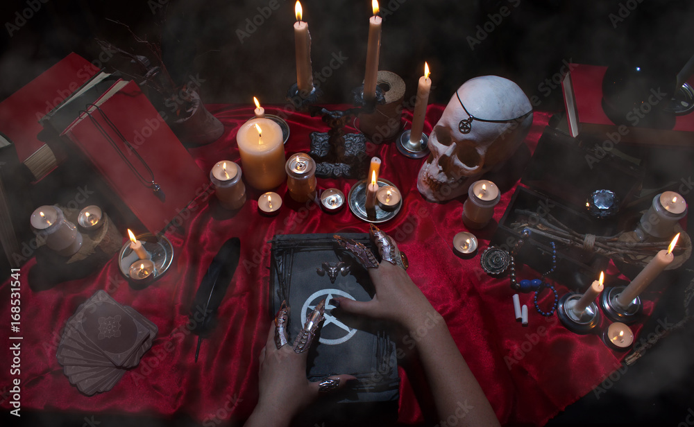 Witchcraft composition with witch's hands, satanic magic books, skull ...