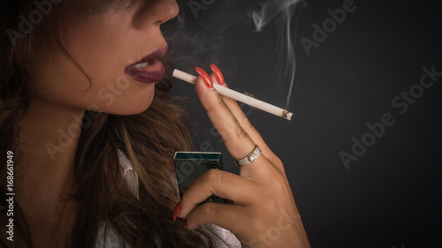 Portrait of sexy elegant lady woman smoking cigarette. Fashion glamour ...