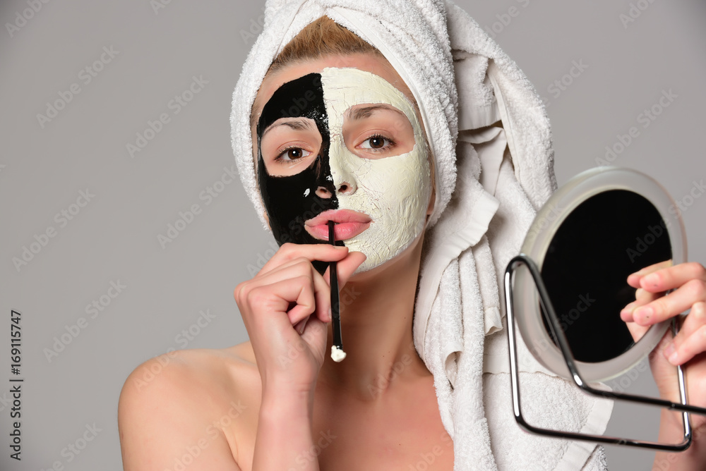 beautiful female model with facial cosmetic mask posing. Isolated on ...