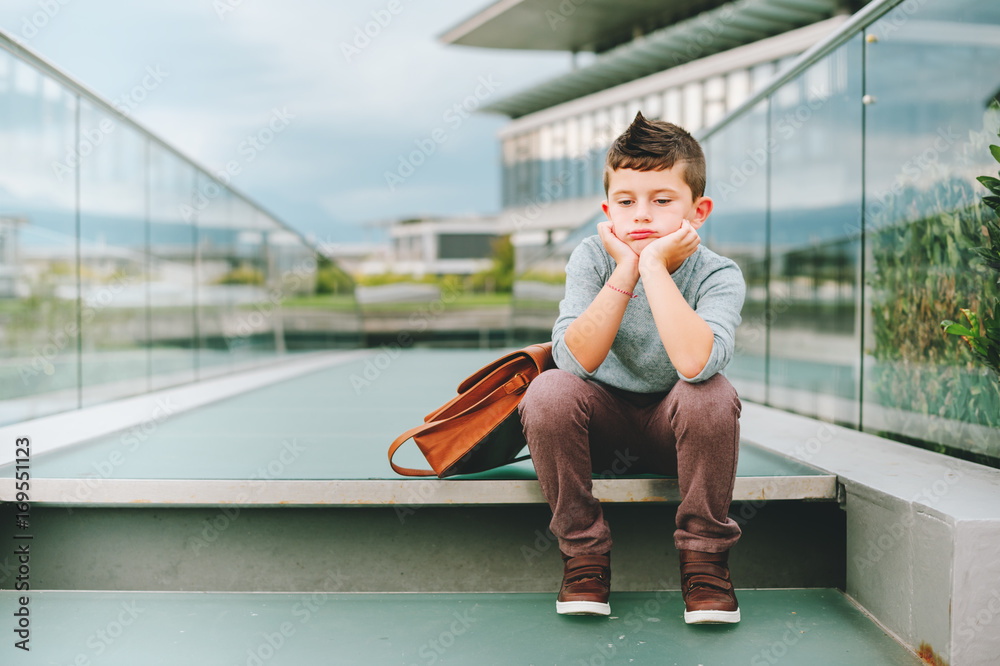 Sad kid boy resting outdoors. Bored little student Stock Photo | Adobe ...