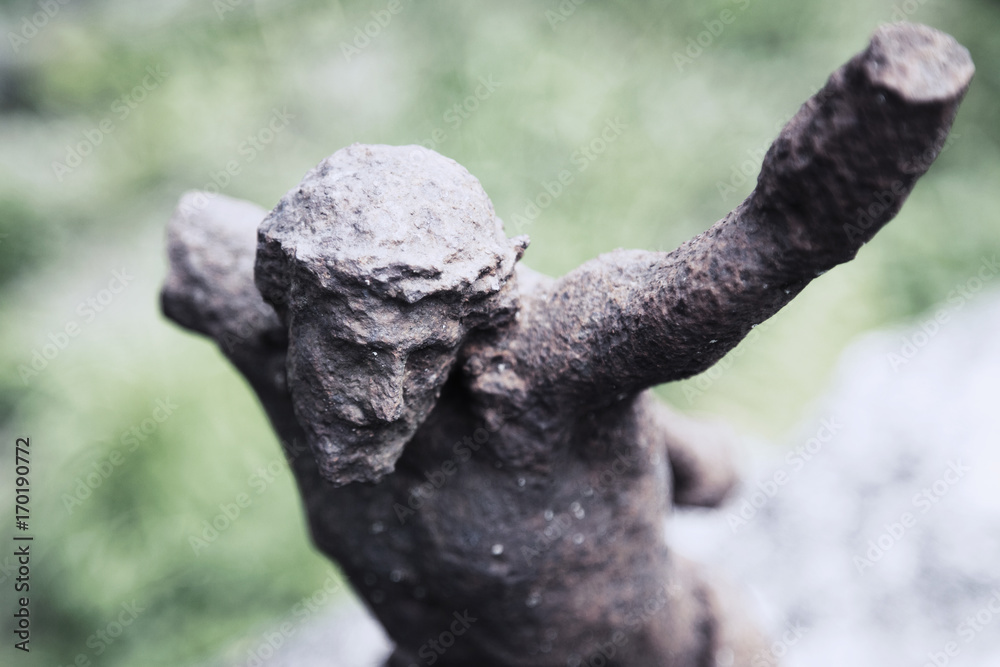 Partially destroyed ancient statue of the crucifixion of Jesus Christ ...