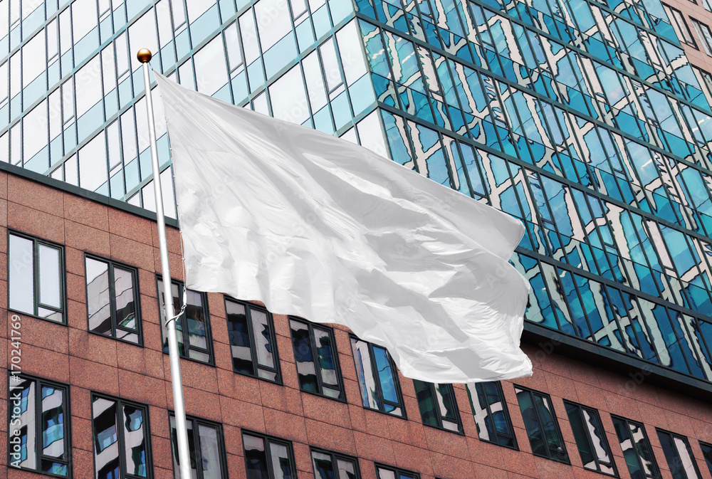 White blank flag waving in the wind in the urban background of modern ...