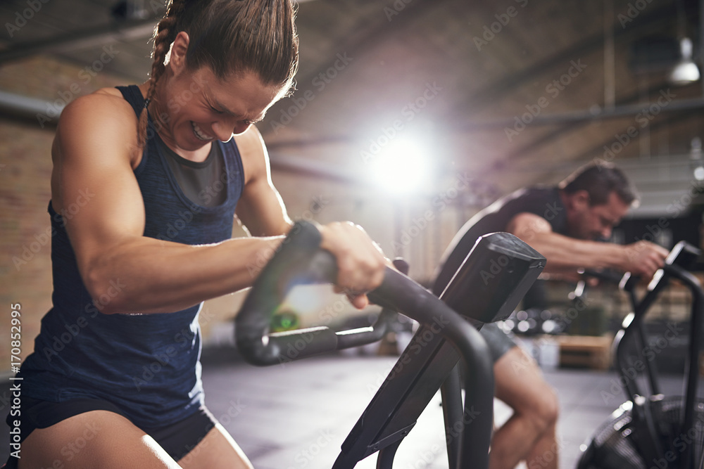 Sportsmen working out hard on cycling machines Stock Photo | Adobe Stock