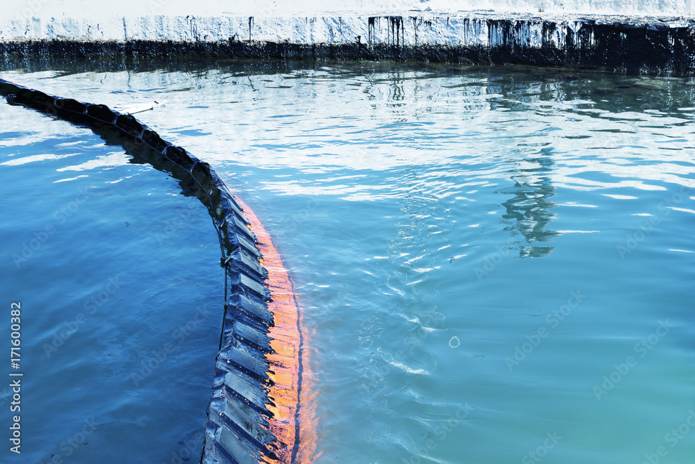 Oil spill. Environmental disaster. A containment boom is a temporary ...