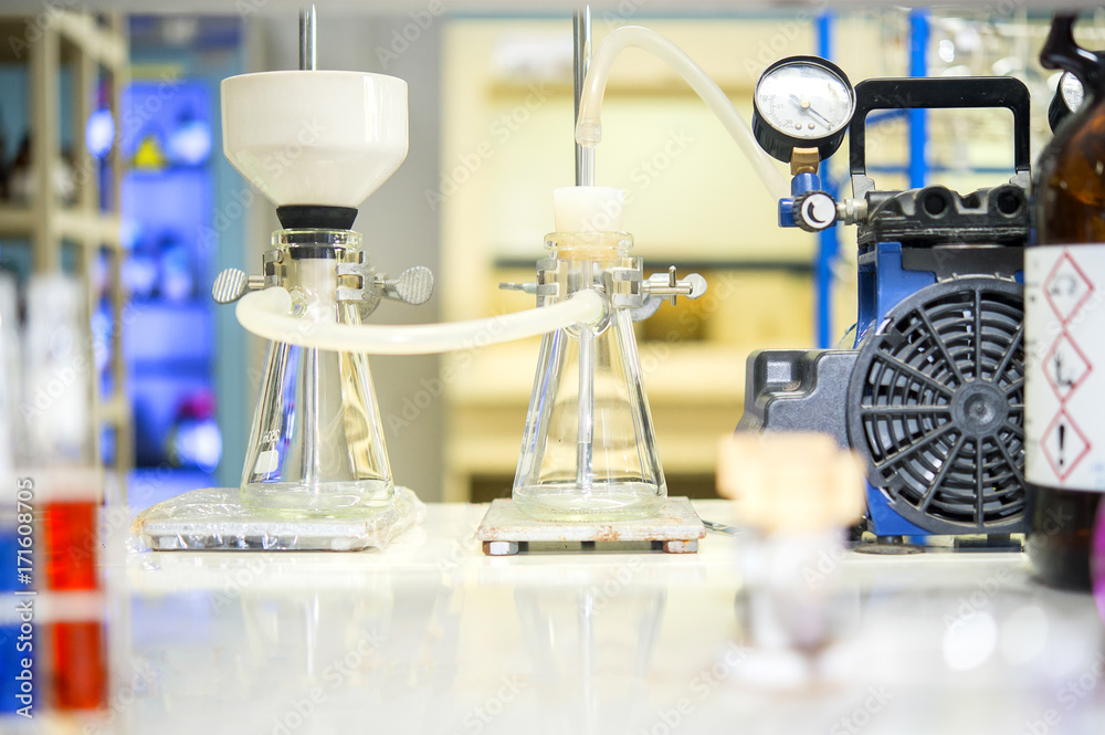 Chemical filtration with Buchner funnel bushings using a vacuum pump ...