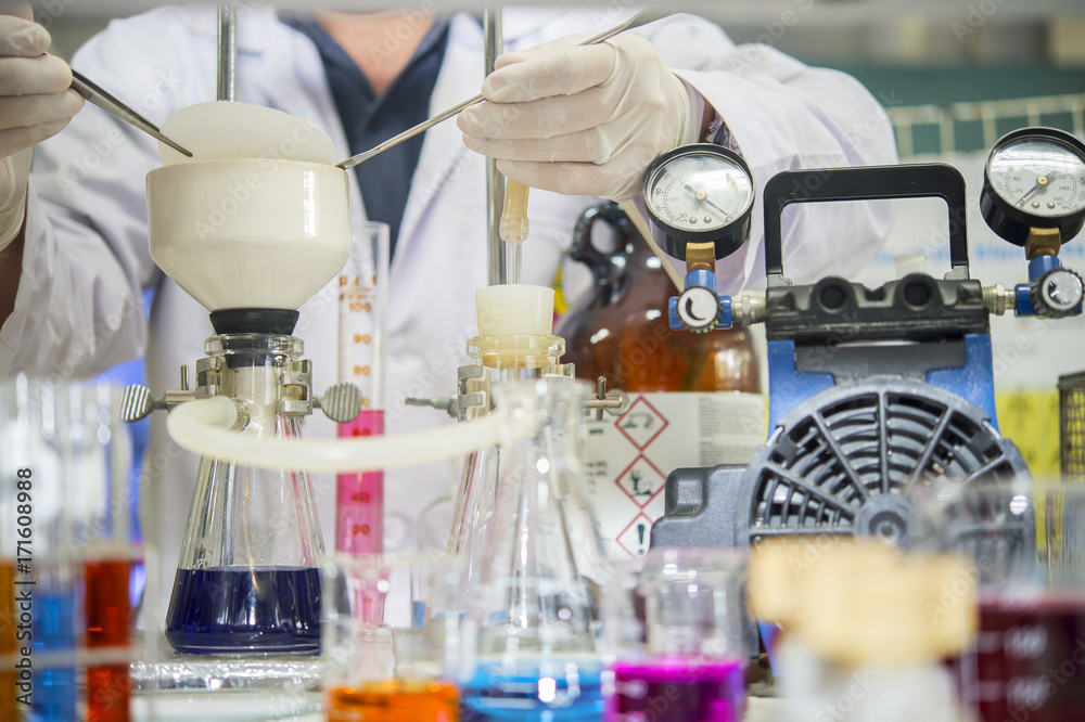 Scientists are using a filter clamp in a buchner funnel for chemical ...