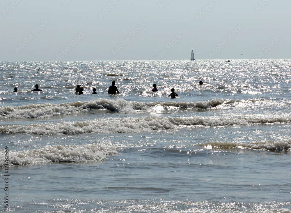 Swimming, boating and sailing at the seaside on a hot summer's ...