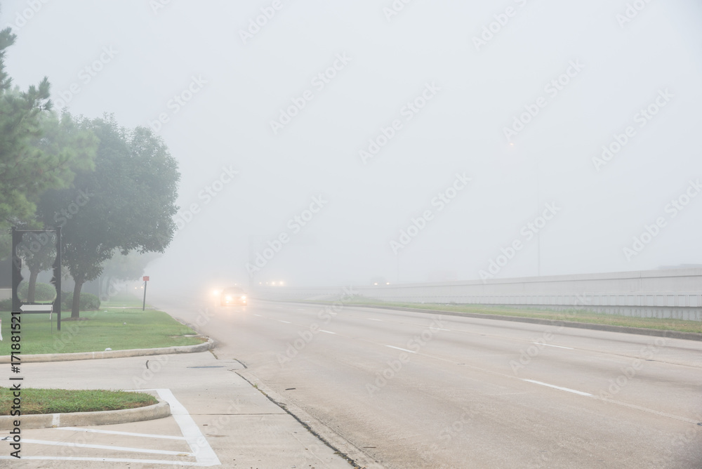Morning foggy city frontage road with traffic sign and car silhouette ...
