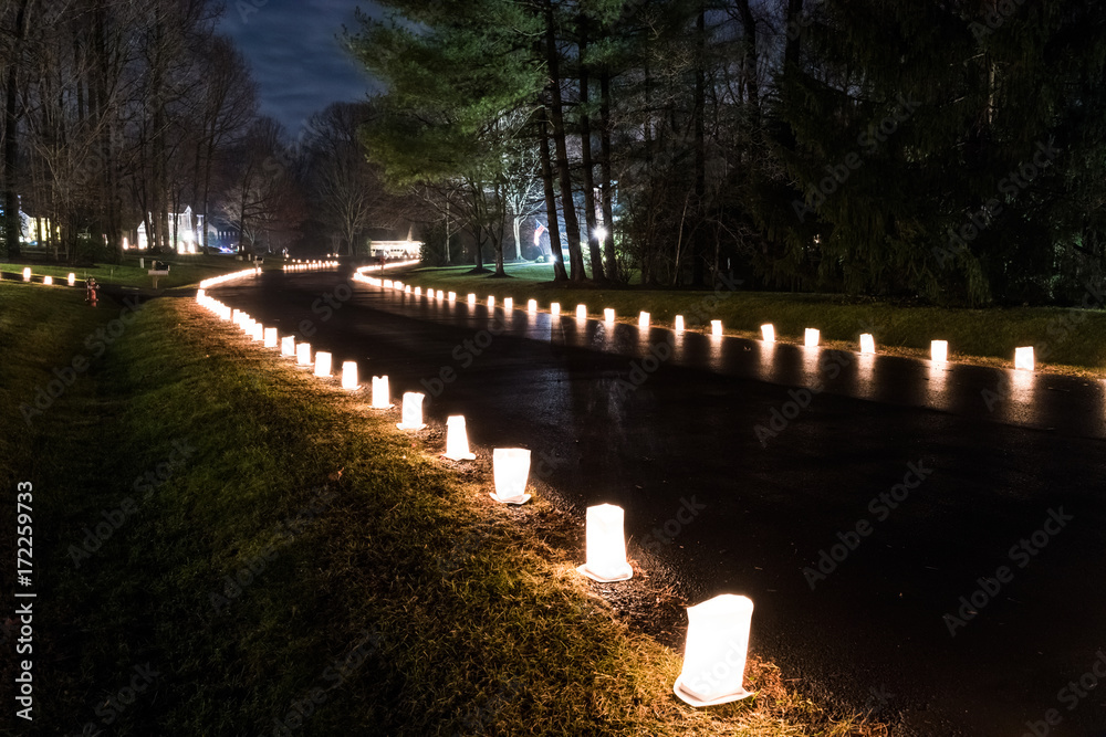 Christmas Eve candle lights in paper bags at night along road ...