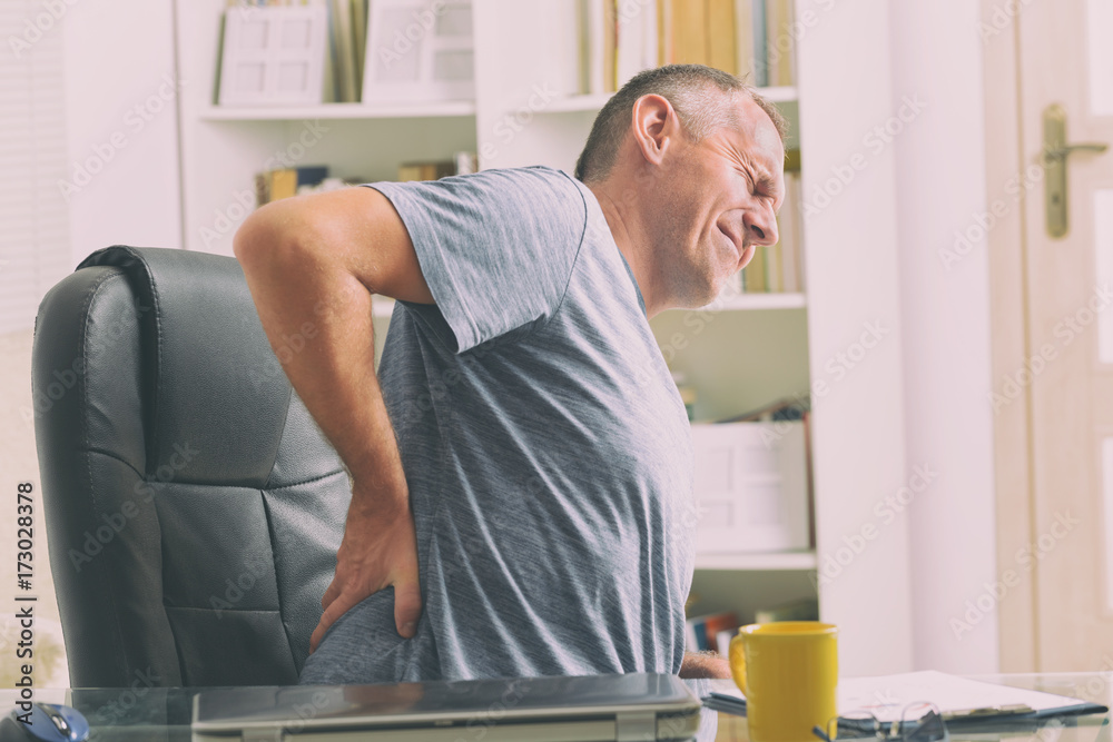 Man suffering from low back pain Stock Photo | Adobe Stock