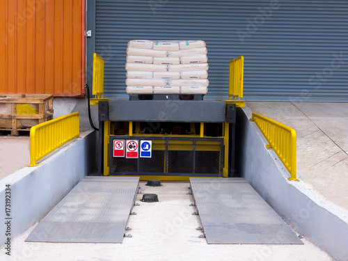 Loading dock leveler ramp outside warehouse building for loading and ...