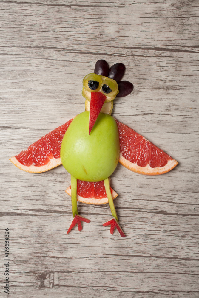 Sad rooster made with fruits on wooden background Stock Photo | Adobe Stock