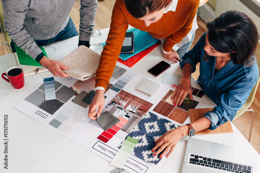 Group of creative interior designer architects discussing furnishings ...