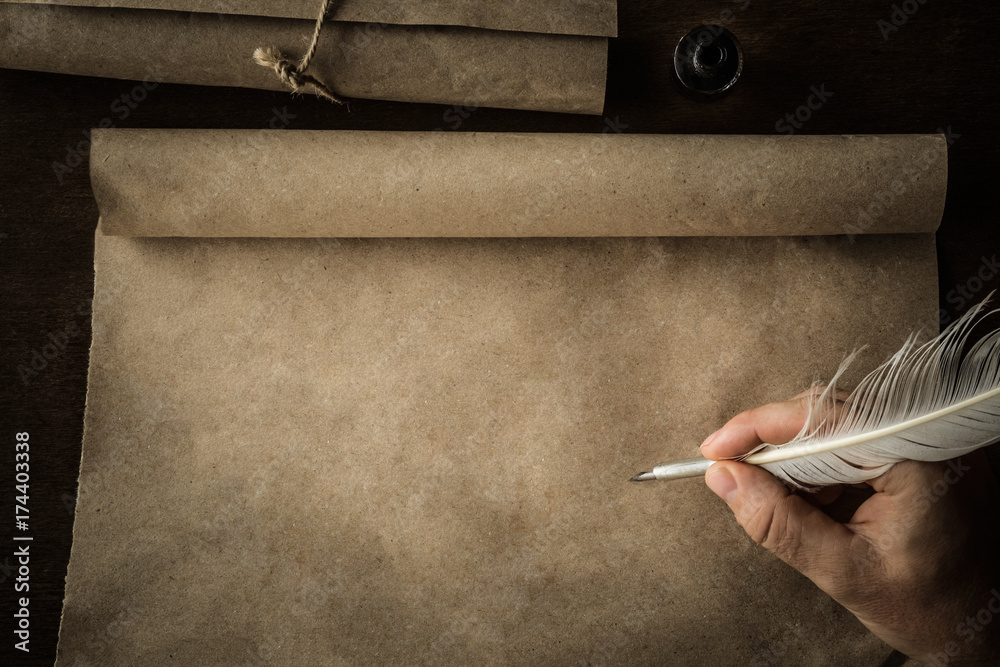 Hand writing with old quill pen on the old paper. Historical atmosphere ...