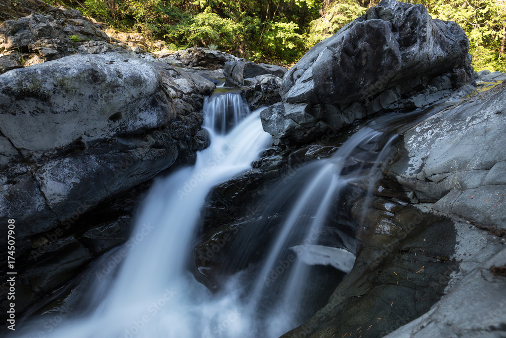 Water spring running down the smooth rocks in a beautiful canyon. Taken ...