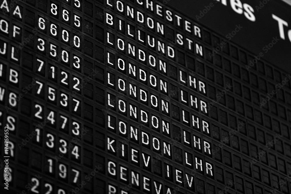Departures board at the airport. Flight information mechanical ...