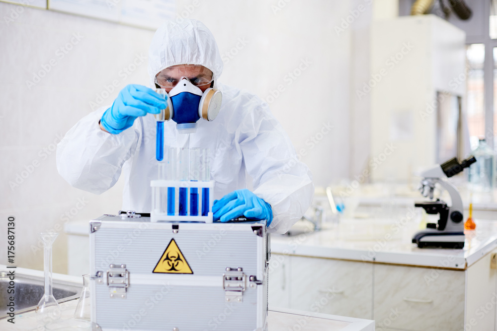 Talented virology research scientist wearing coverall and respirator ...
