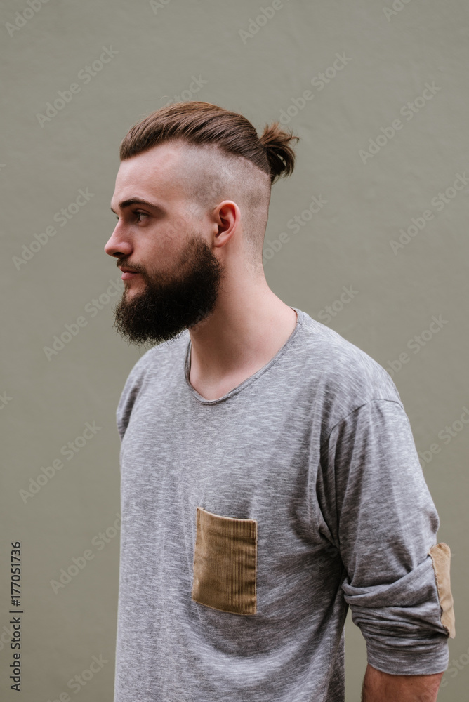 Portrait of a handsome bearded man with samurai bun hairstyle Stock ...