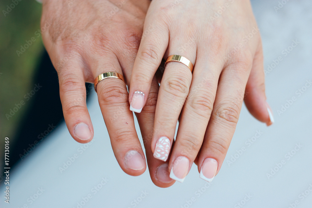 hands of husband and wife with wedding rings. Stock Photo Adobe Stock