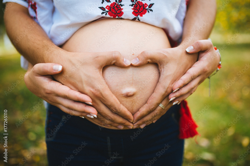 Pregnant Belly with fingers Heart symbol. Beautiful Young Pregnant ...