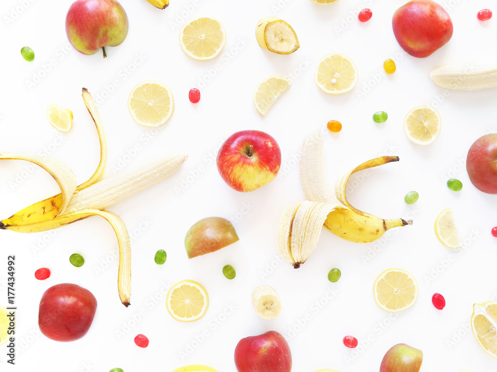 Composition of bananas, lemons and apples on a white background, flat ...