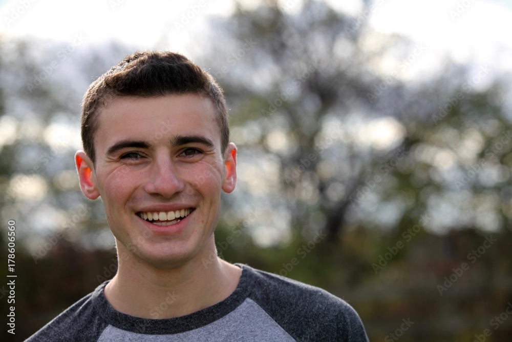Portrait head shot of a teenage boy smiling Stock Photo | Adobe Stock