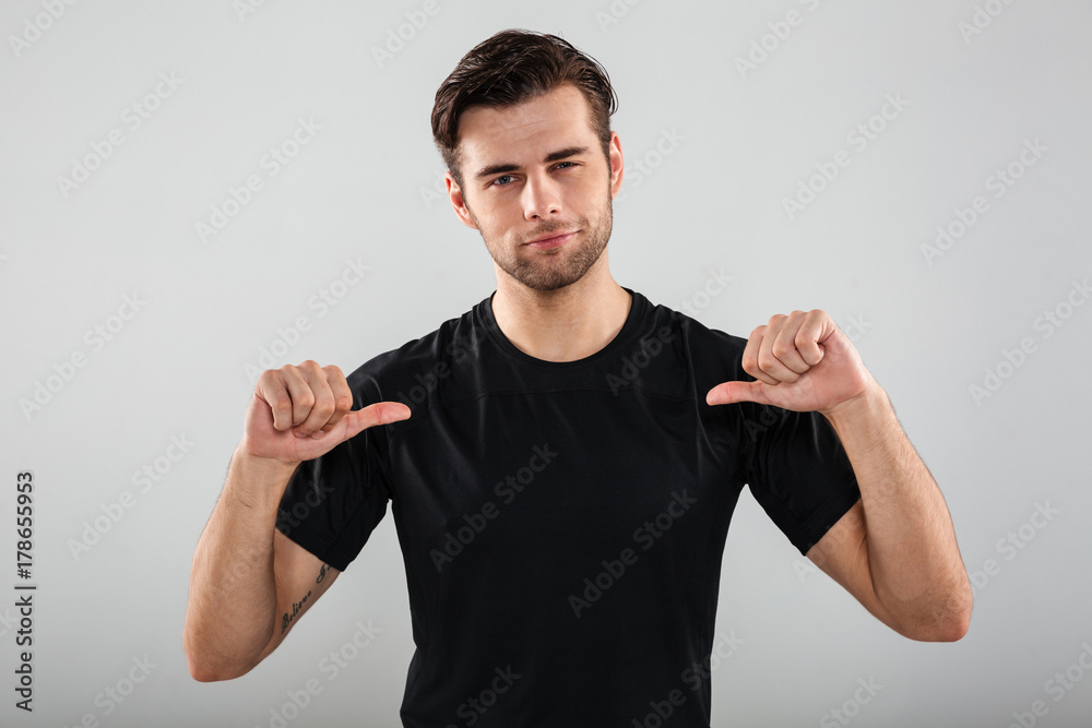 Handsome young sports man pointing to himself. Stock Photo | Adobe Stock