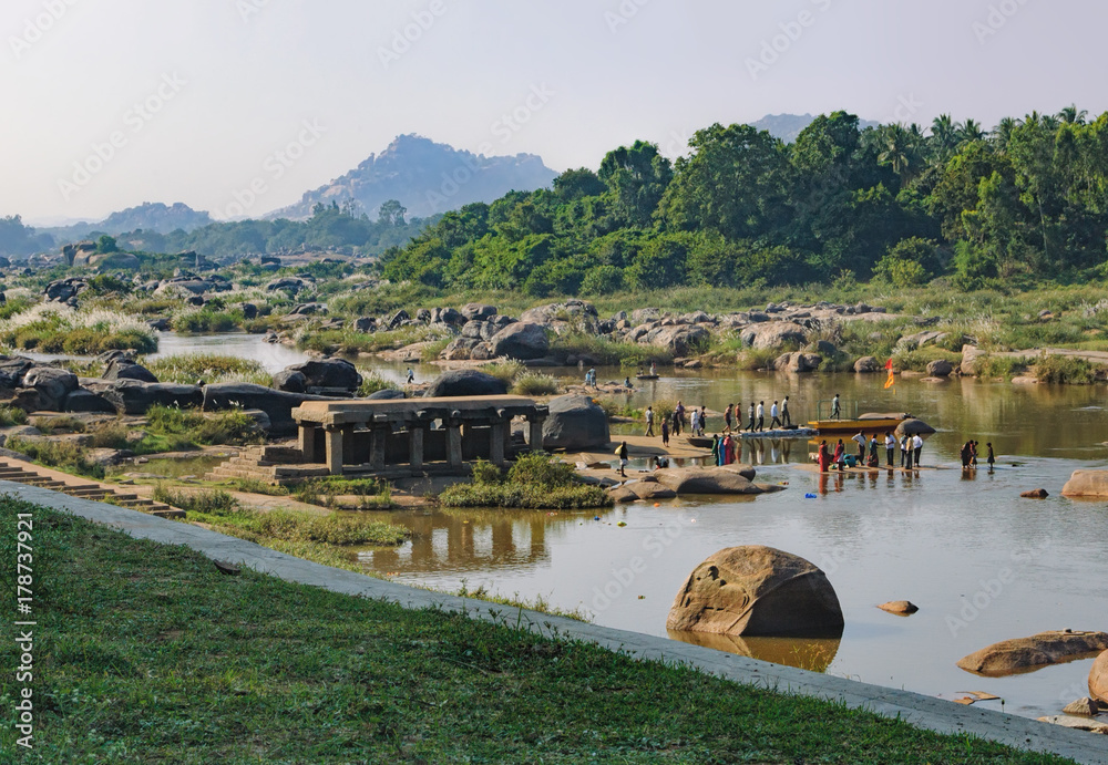 Tourists crossing Tungabhadra River with small ferry, Hampi, Karnataka ...