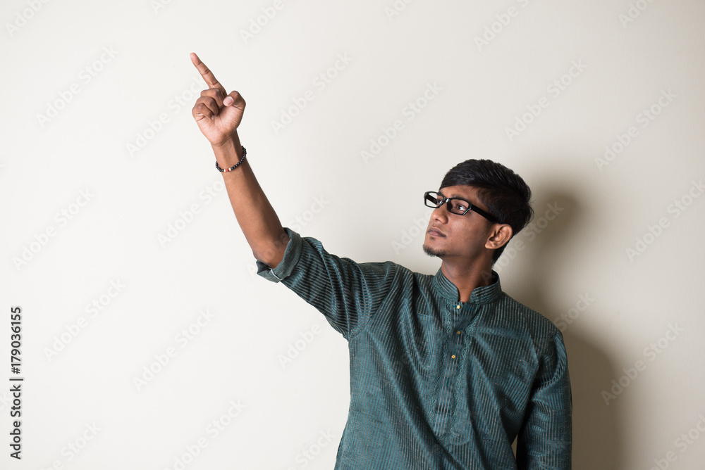 teenage indian male in traditional dress pointing somewhere Stock Photo ...