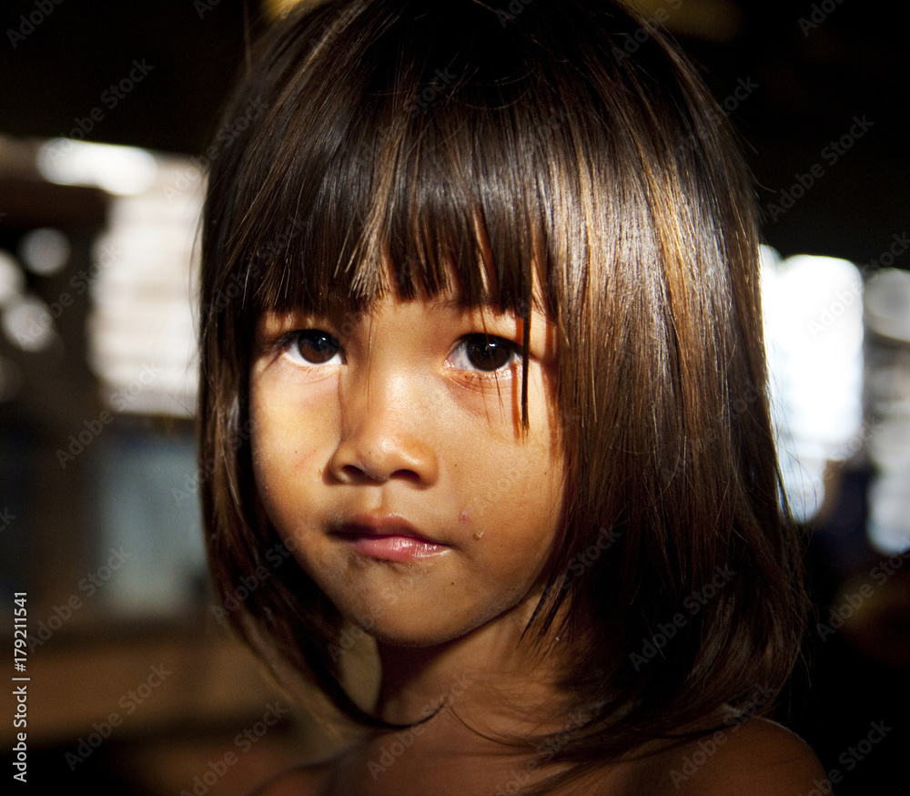 Little girl staring at the camera. Stock Photo | Adobe Stock