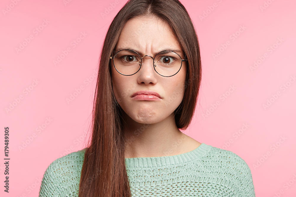Aggravated brunette female with long straight dark hair, wears ...