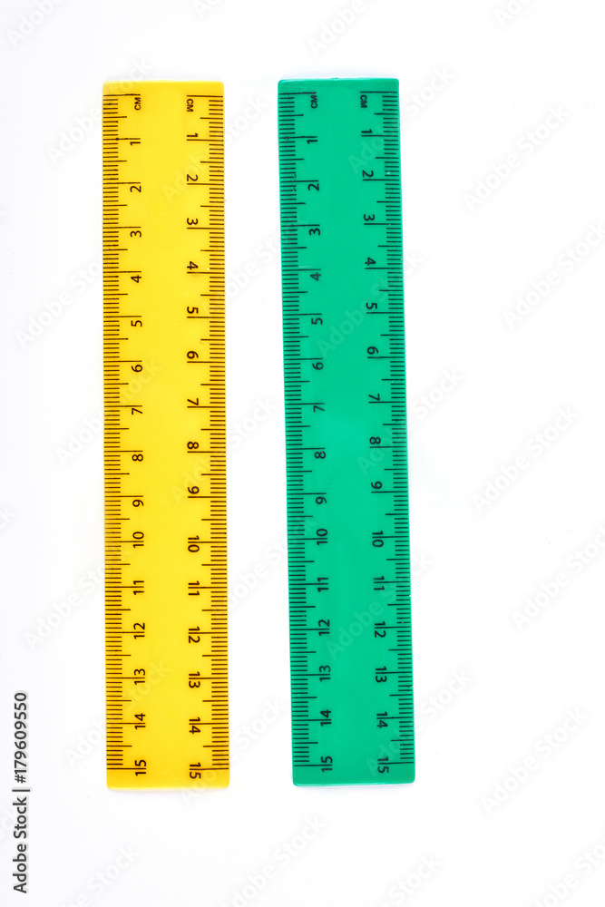 Yellow and green plastic rulers. Two fifteen centimeters rulers for ...
