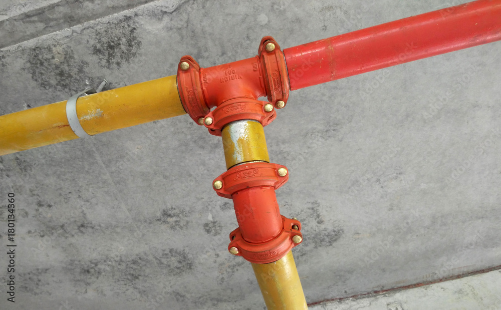 Sprinkler system pipe in hang at the slab soffit. Sprinkler is an ...