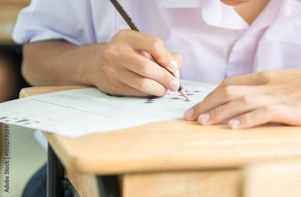 Asian Boy Students taking exams, writing examination room with ...