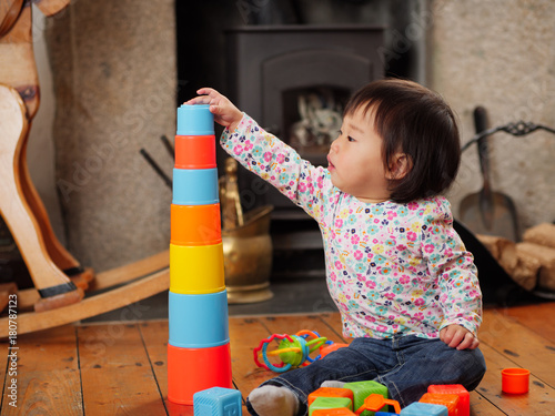 baby girl playing stacking cups at home Stock Photo | Adobe Stock