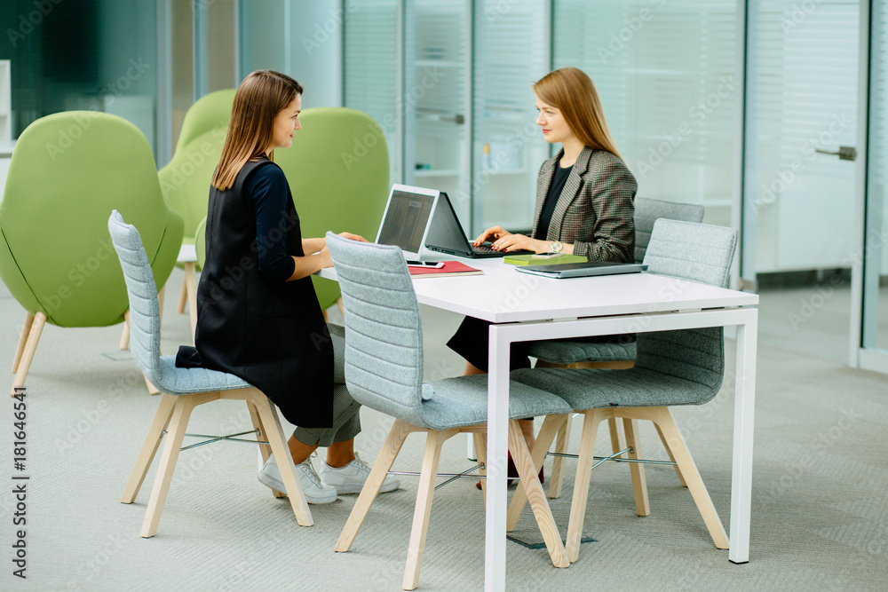 Two people talking in open space comfortable office. Business, work and ...