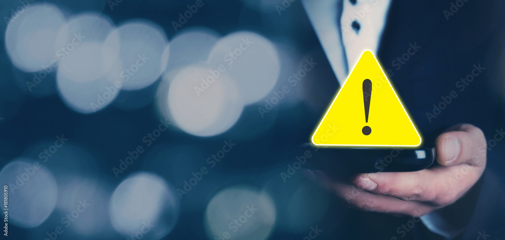 Man holding warning sign. Stock Photo | Adobe Stock