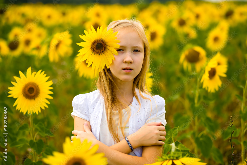 girl walking and posing in field with sunflowers Stock Photo | Adobe Stock