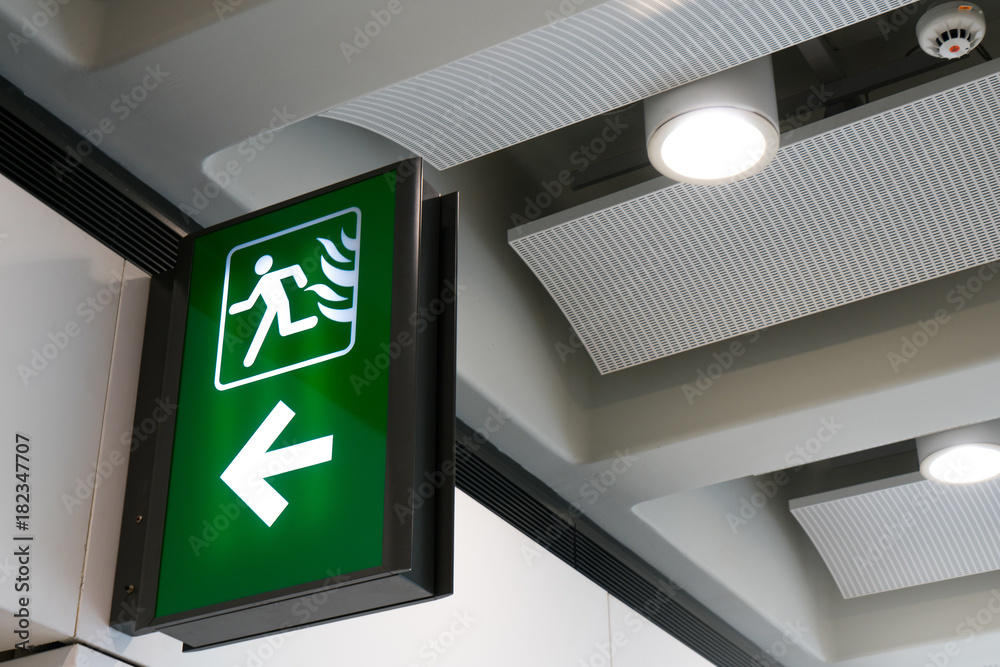 Fire exit sign lightbox in the airport terminal emergency exit way ...