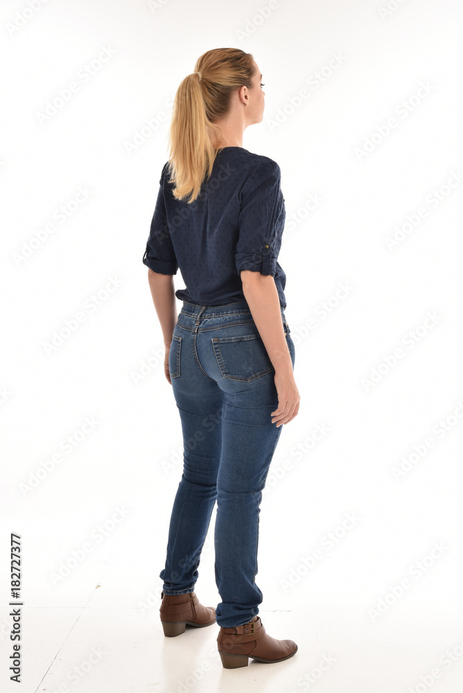Full length portrait of a girl wearing simple blue shirt and jeans ...