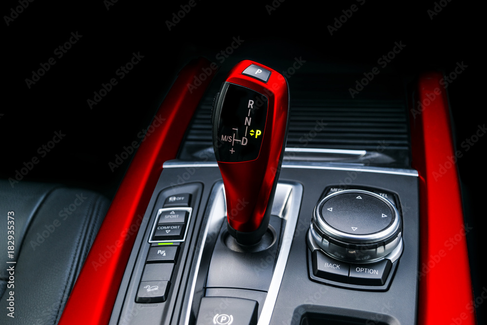 Red Automatic gear stick (transmission) of a modern car, multimedia and navigation control ...