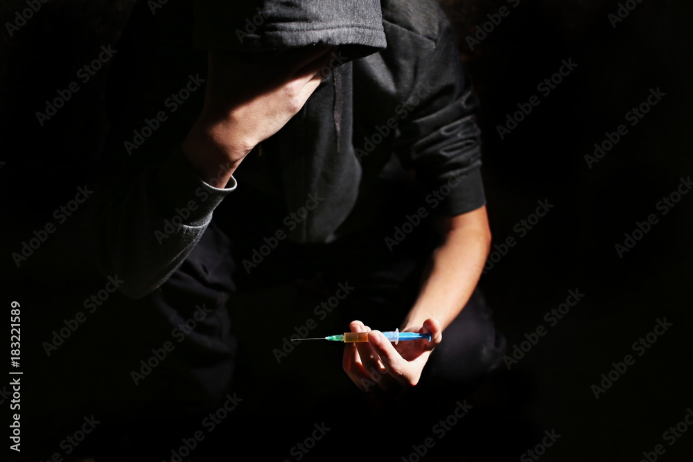 Drugs concept. Disease concept. Drug addict man with syringe using ...