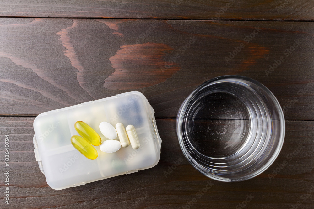 White and yellow capsules of glucosamine, omega-3 pills of calcium on ...