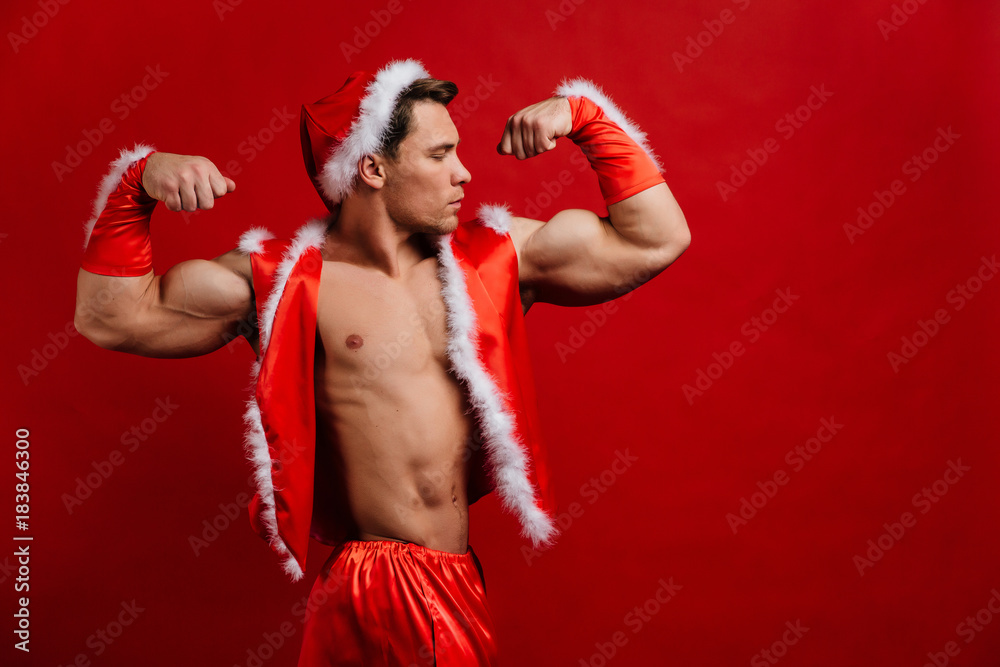 christmas holidays. sexy strong santa claus wearing hat. Young muscular ...