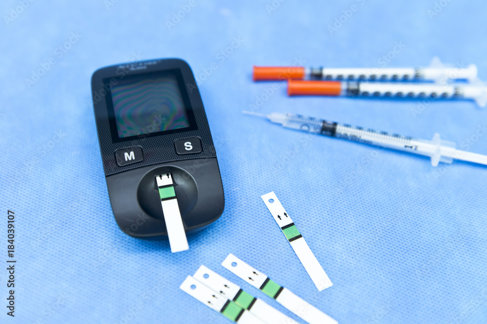 Foto de Stock Small blood glucose meter, test strips, and insulin ...
