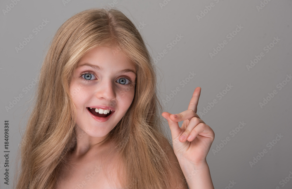 Look at this. Portrait of playful delighted little girl with naked ...